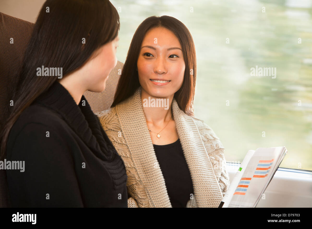 Two women train talking hi-res stock photography and images - Alamy