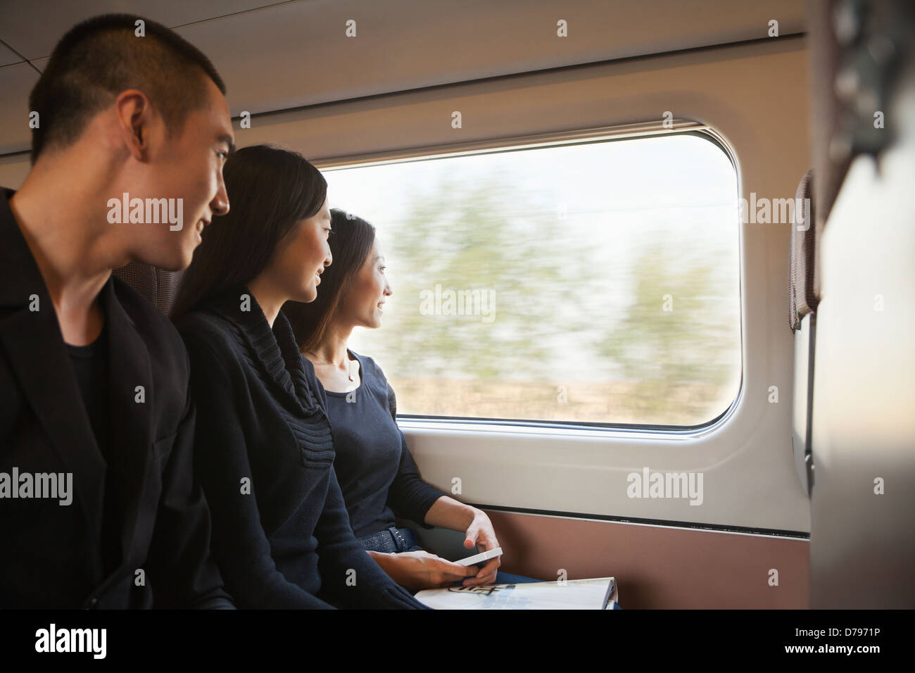 Three Friends Looking Out Train Window Stock Photo - Alamy