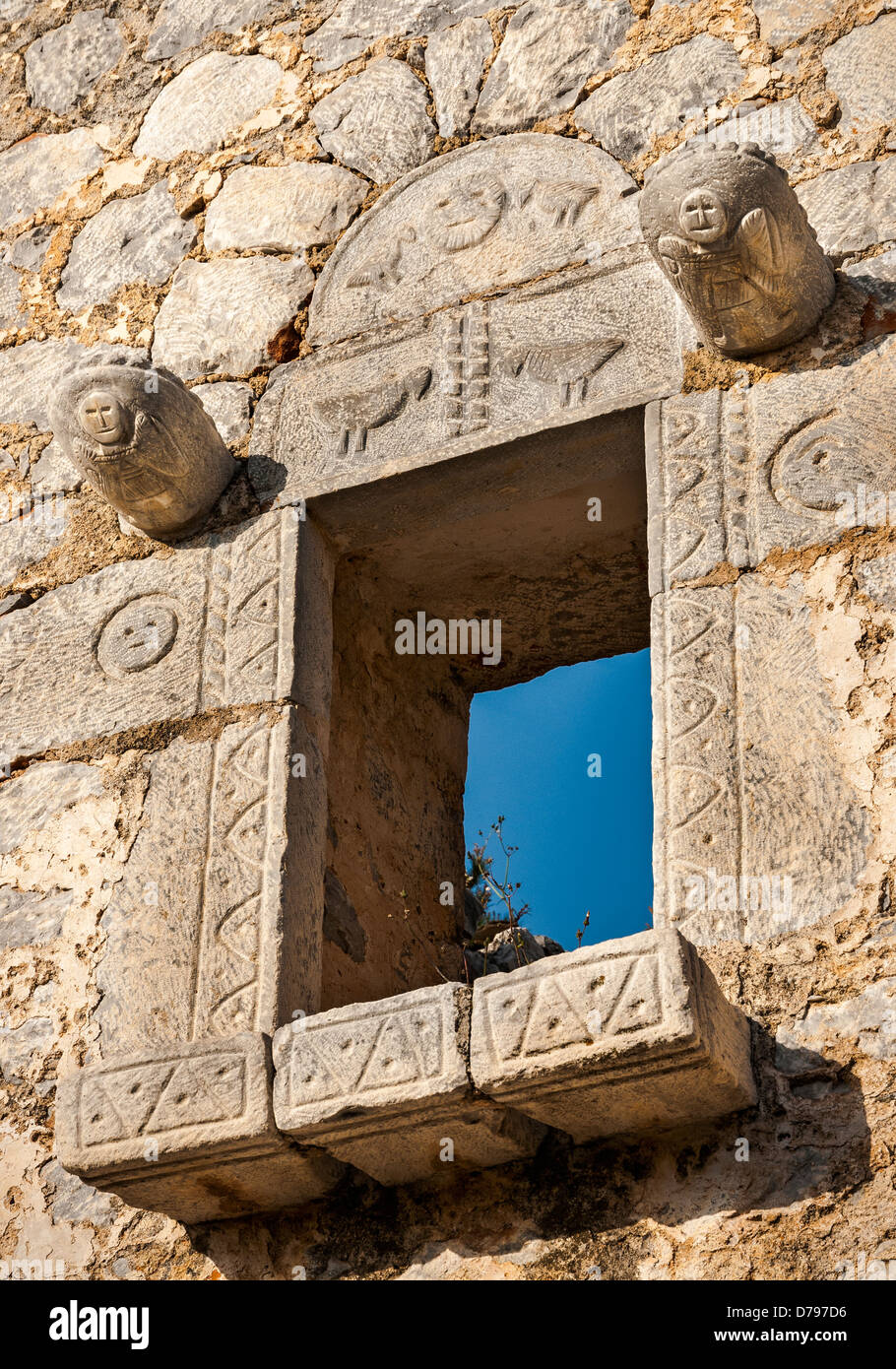 Traditional Maniot stone carving of angels and birds on a window in the ...