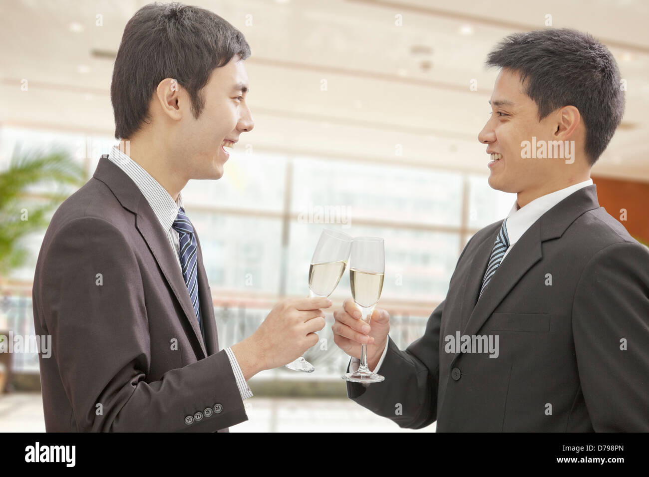 Two Businessmen Toasting Champagne Flutes Stock Photo - Alamy