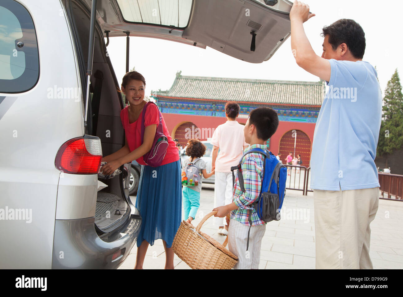 Family taking stuff out from the car, preparing for picnic Stock Photo ...