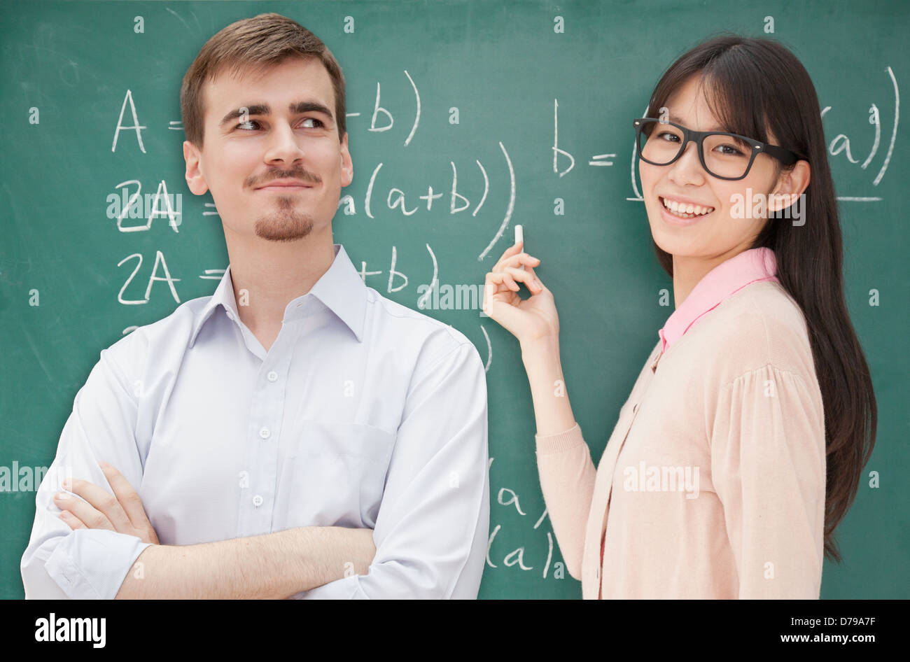 Two students doing math formula on the chalkboard, Beijing Stock Photo ...