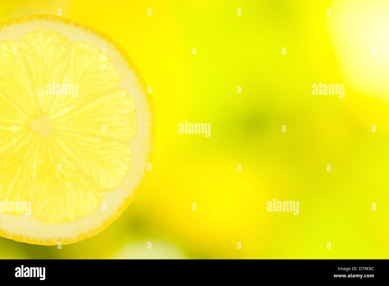 slice of lemon fruit on yellow and green blur background with empty ...