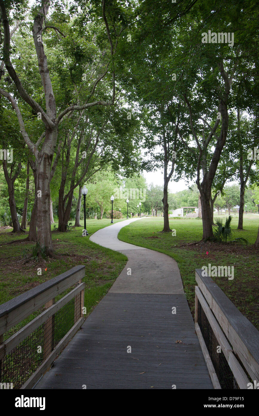 A quiet, tree-lined bridge and walking trail in Chapman Botanical ...