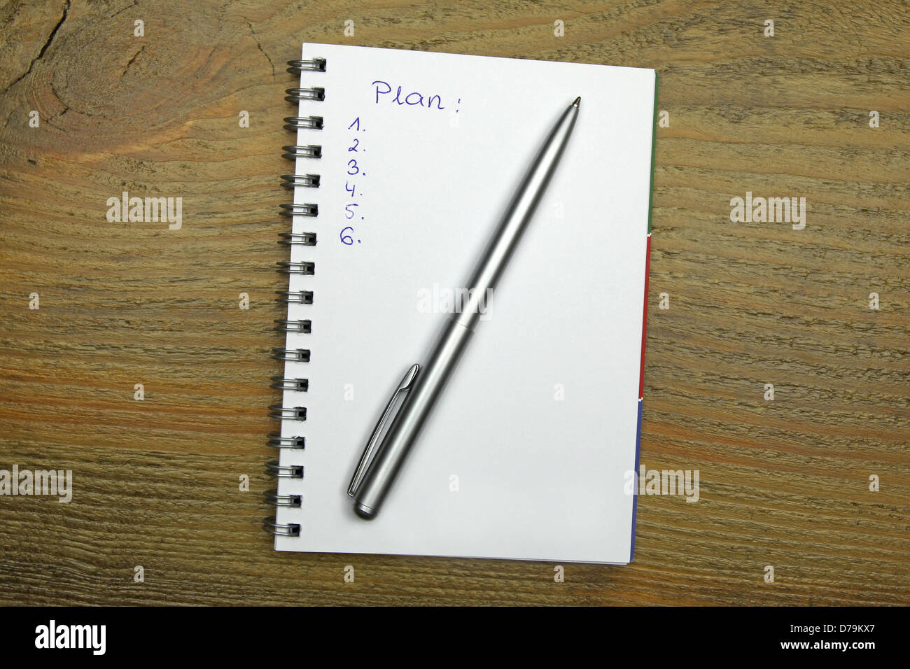 notebook with an action plan on wooden desk Stock Photo - Alamy