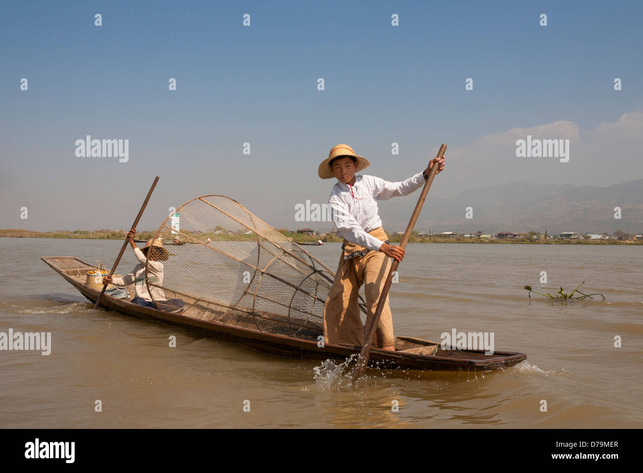 Intha fishermen fishing in a traditional fishing boat, Inle Lake ...