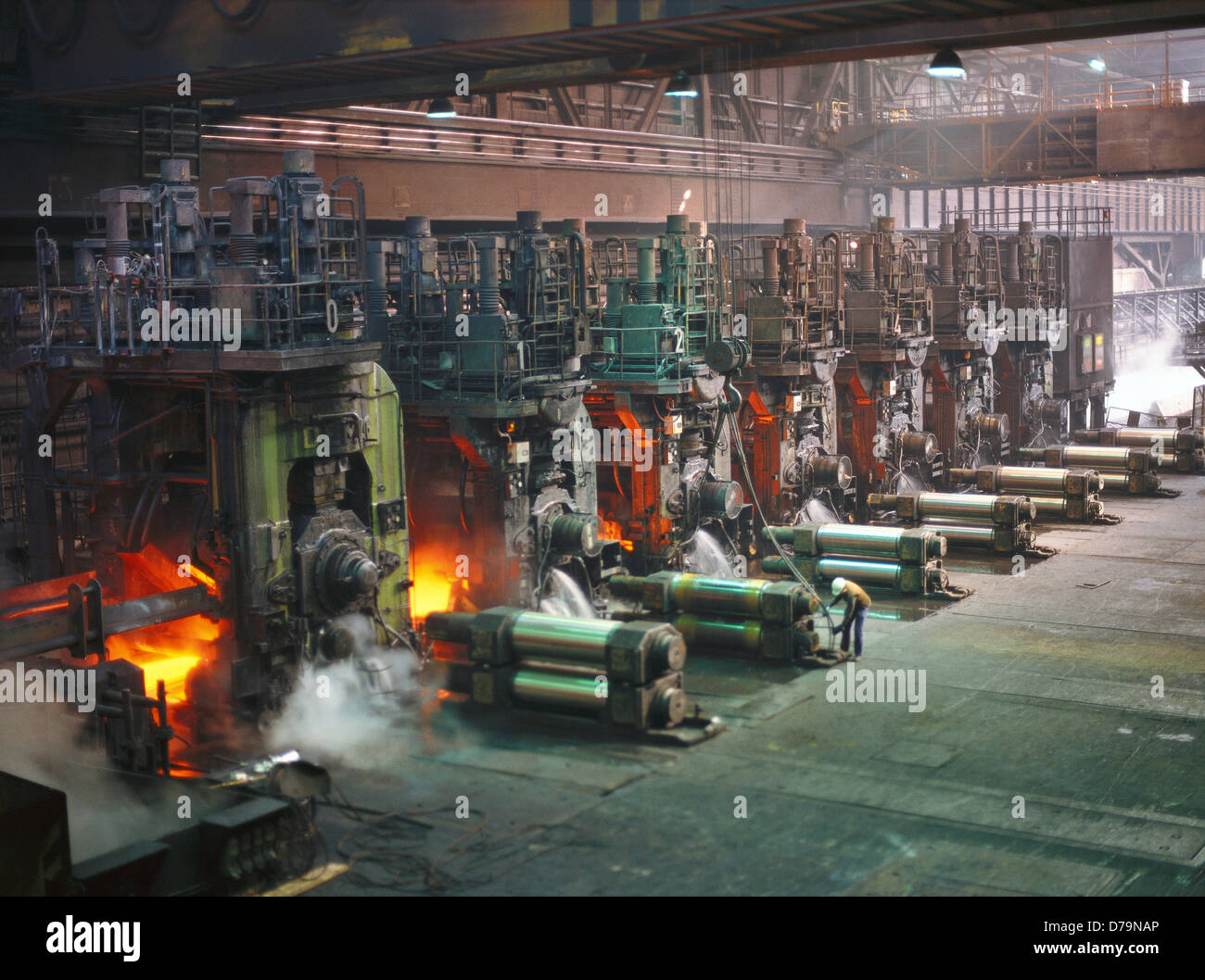 Strip glowing steel being rolled in rolling mill Stock Photo - Alamy
