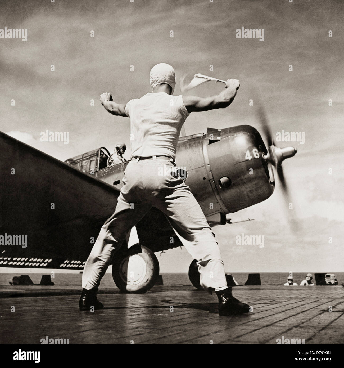 Signalman Gestures to Pilot on Aircraft Carrier Stock Photo - Alamy