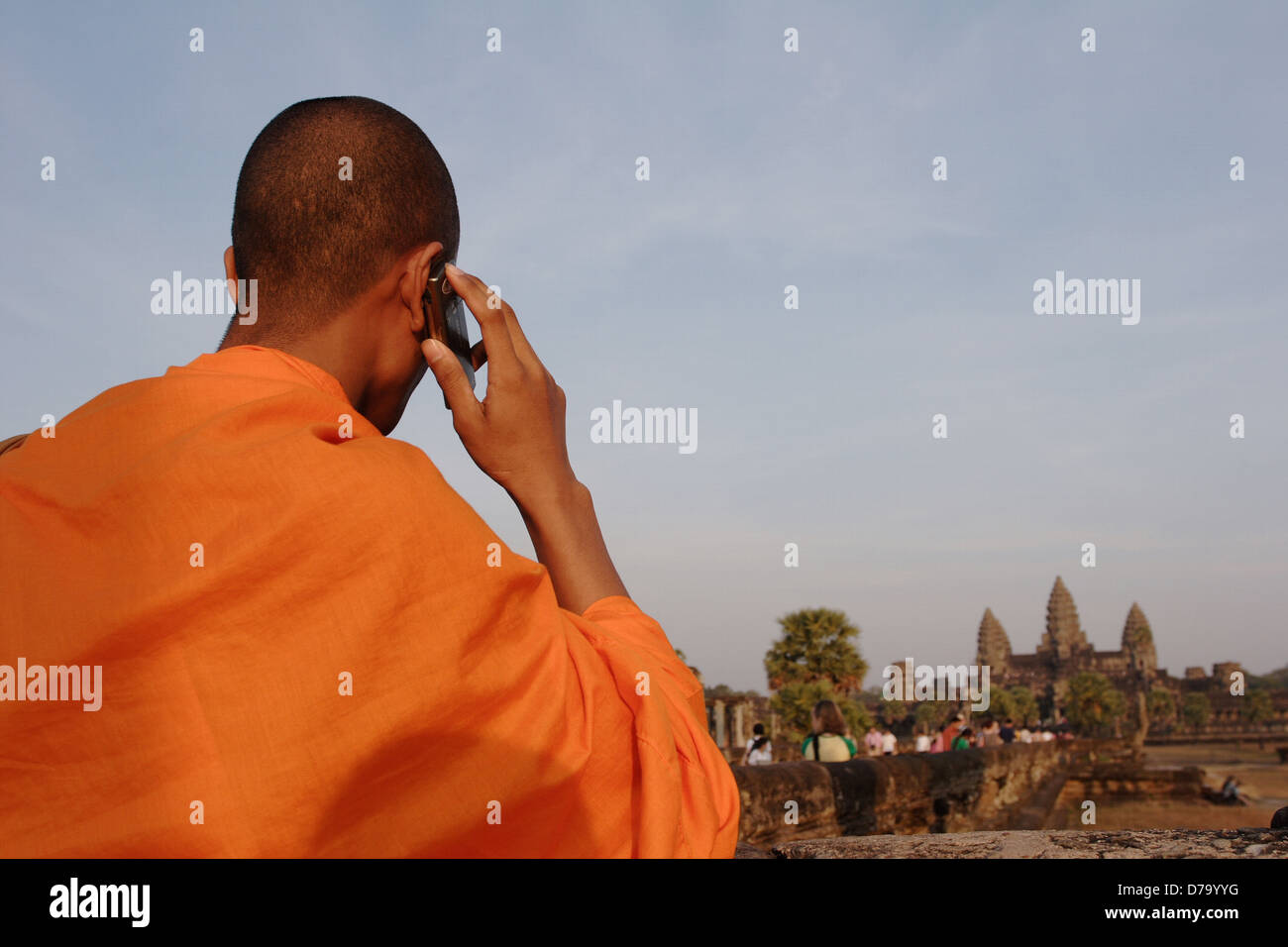 A monk speaks on his mobile phone while crossing the inner causeway to ...