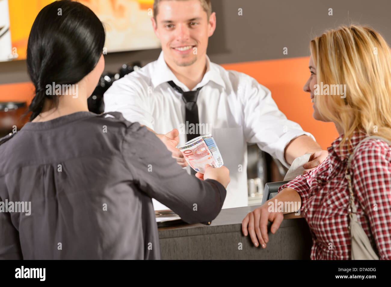 Female cashier giving money hi-res stock photography and images - Alamy