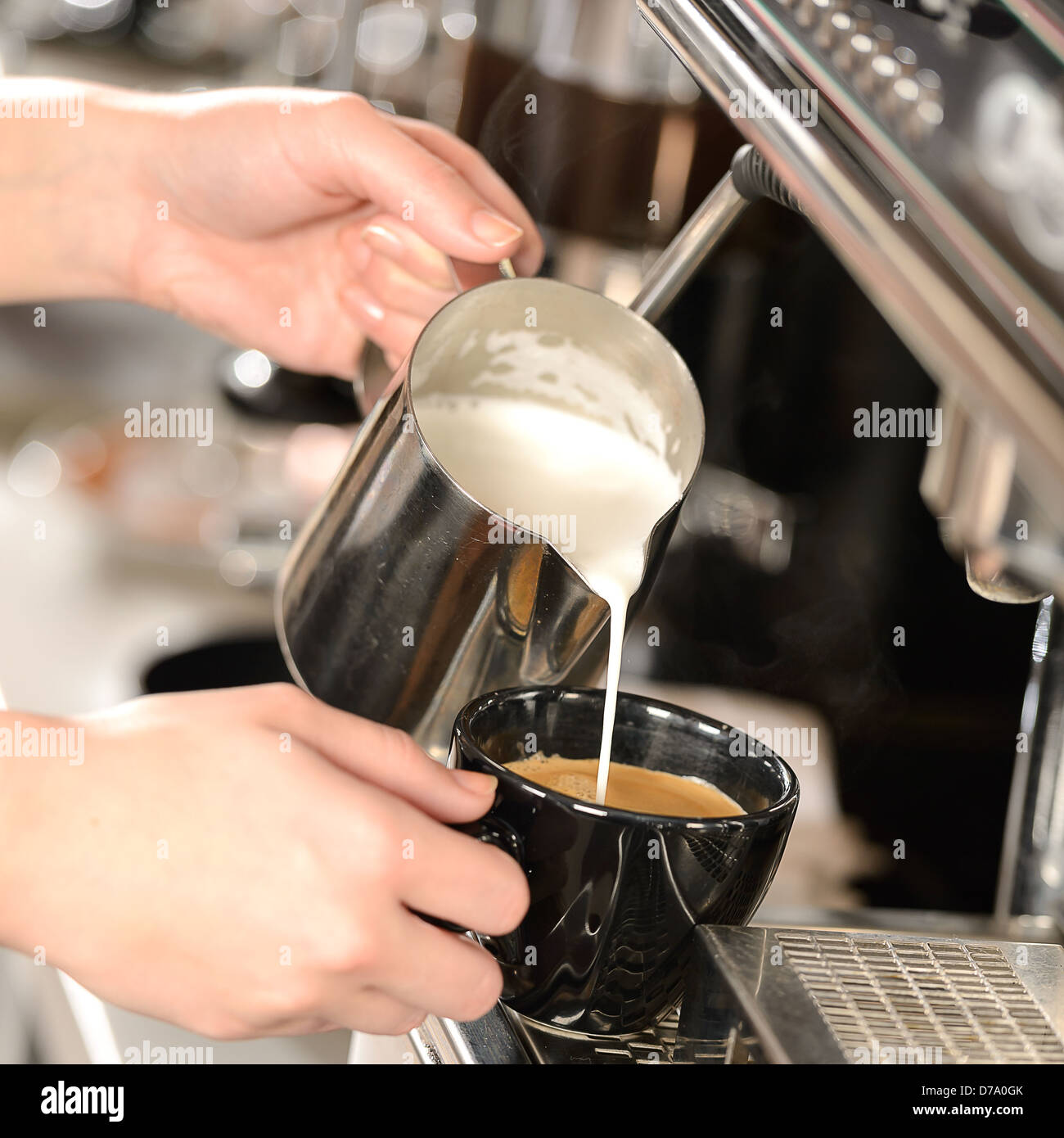 Waitress hands pouring milk making cappuccino Stock Photo - Alamy