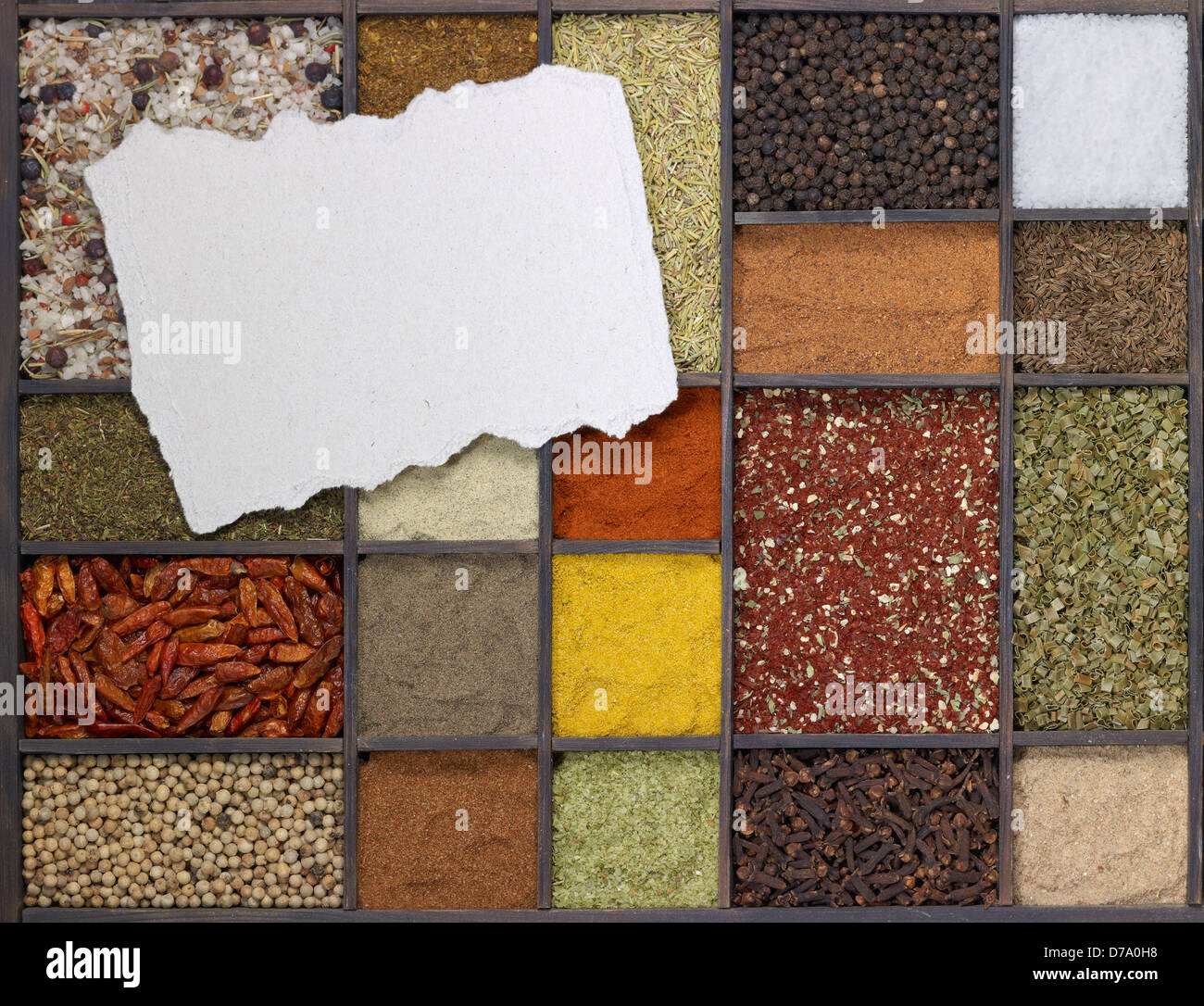 lots of various different spices in a framed dark wooden box with a ...