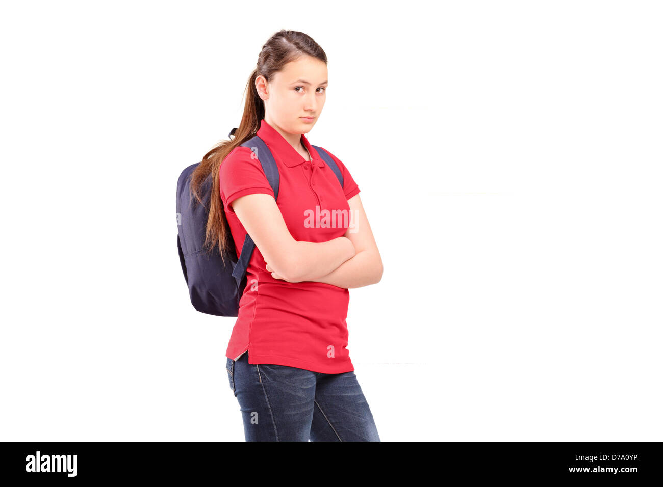 A sad female teenager with a backpack, isolated on white background ...