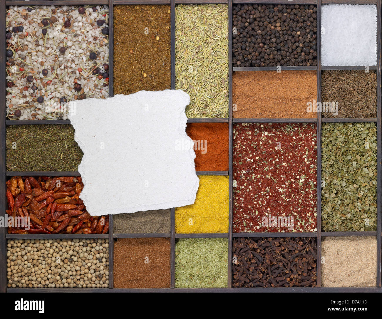 lots of various different spices in a framed dark wooden box with a ...