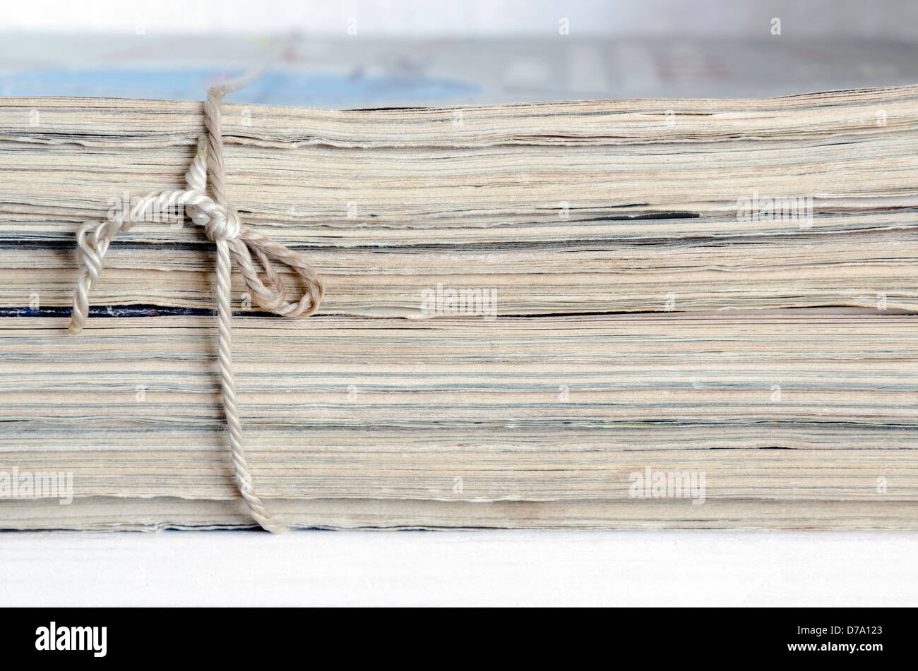 vintage magazines stack tied with old twine on white shelf Stock Photo ...