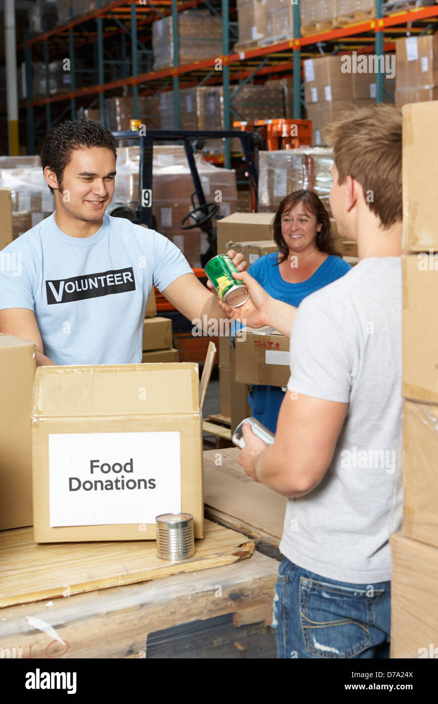 Volunteers Collecting Food Donations In Warehouse Stock Photo - Alamy