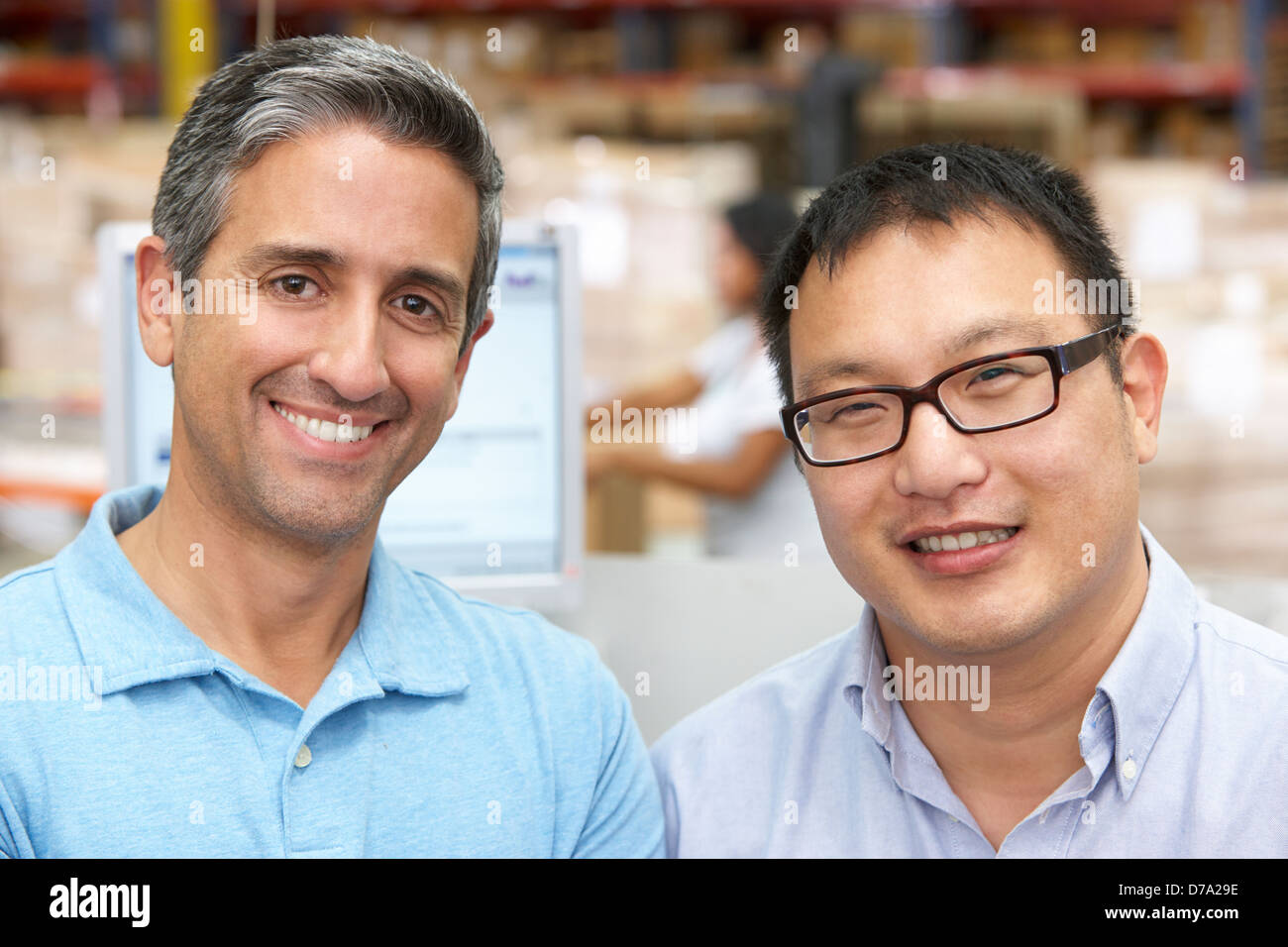 Two Men At Computer Terminal In Distribution Warehouse Stock Photo - Alamy