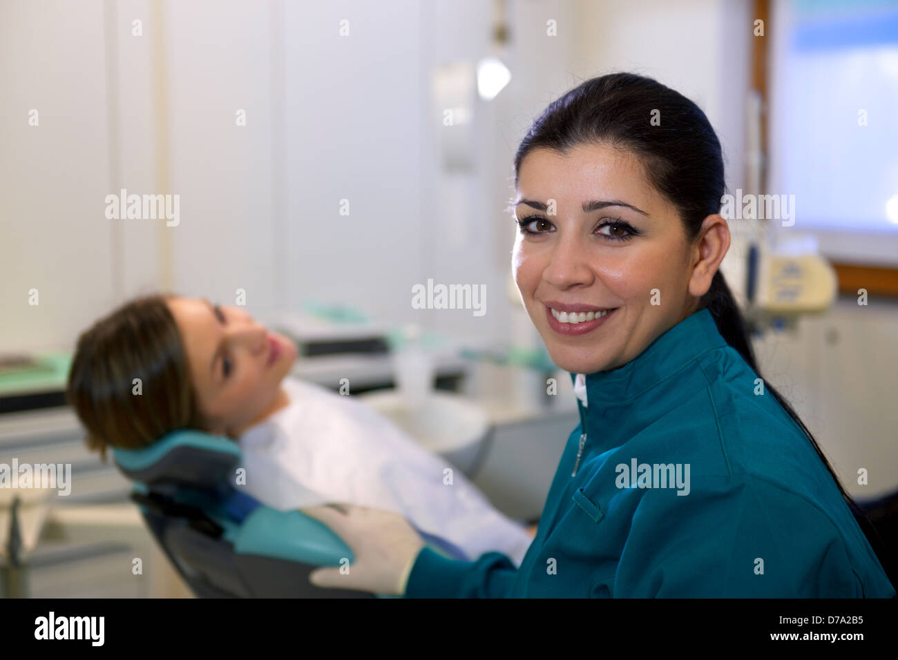 Doctor during visit of woman in dental clinic, portrait of female ...