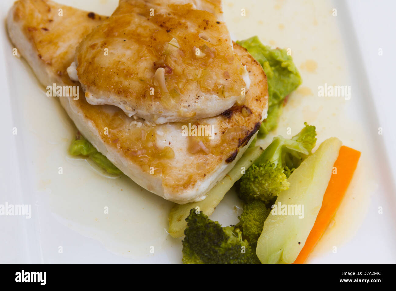 Grilled sea bass on white plate Stock Photo - Alamy