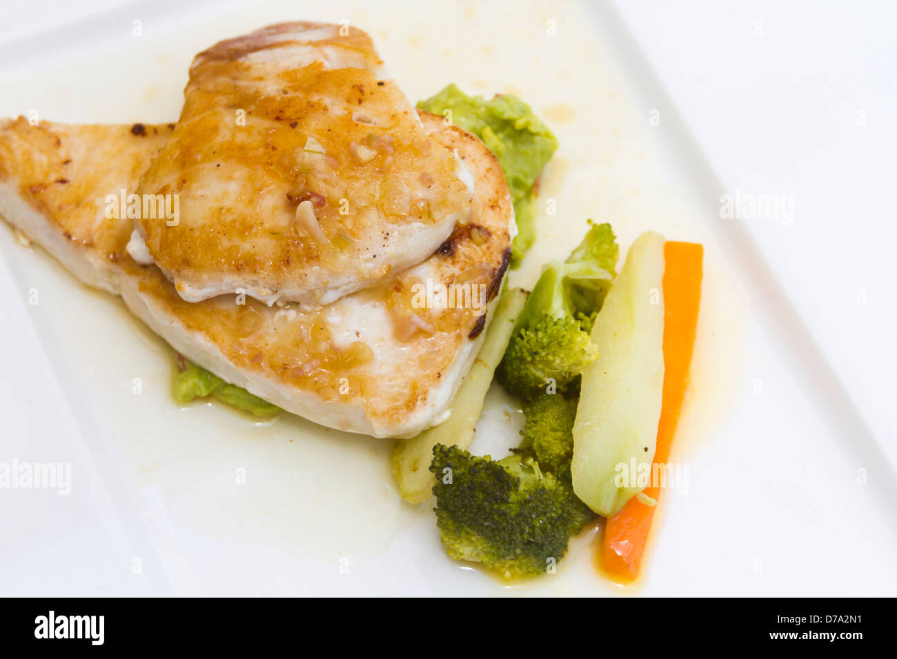Grilled sea bass on white plate Stock Photo - Alamy