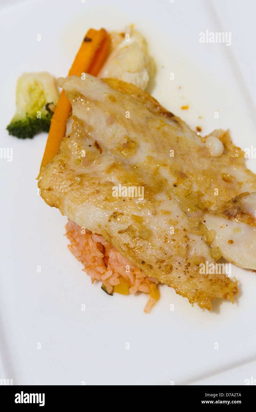 Grilled sea bass on white plate Stock Photo - Alamy
