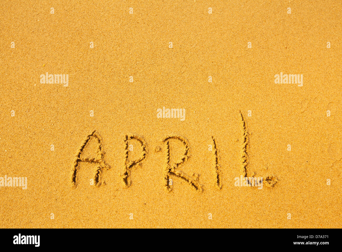 April - written in sand on beach texture (for background Stock Photo ...