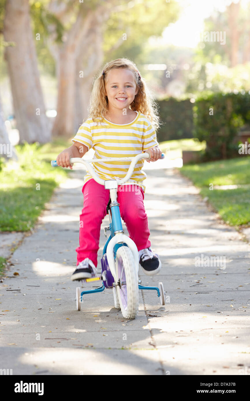 Girl Learning To Ride Bike On Path Stock Photo - Alamy