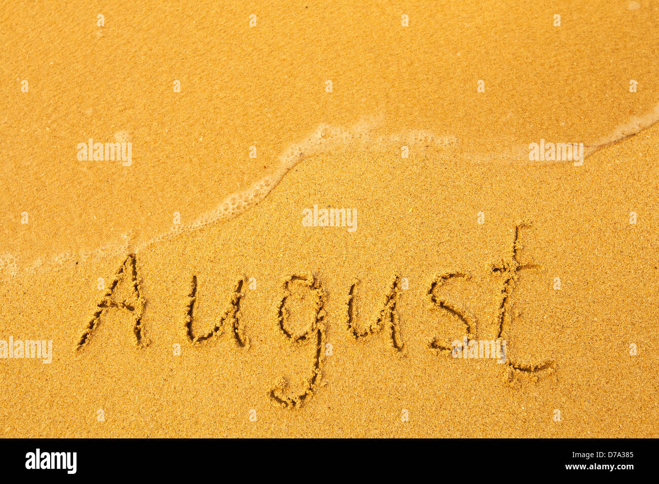 August - written in sand on beach texture (soft wave of the sea Stock ...