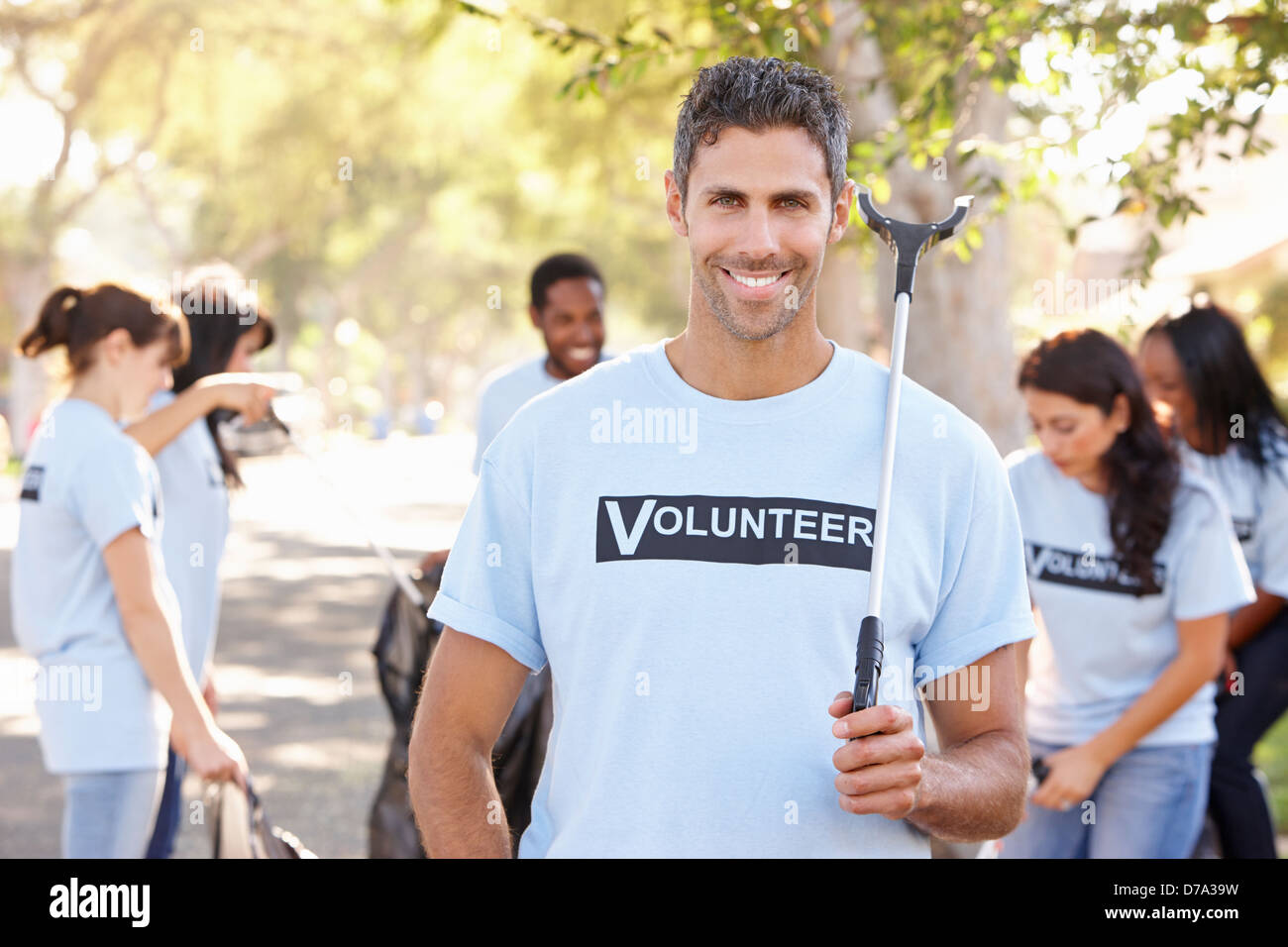 Team Of Volunteers Picking Up Litter In Suburban Street Stock Photo - Alamy