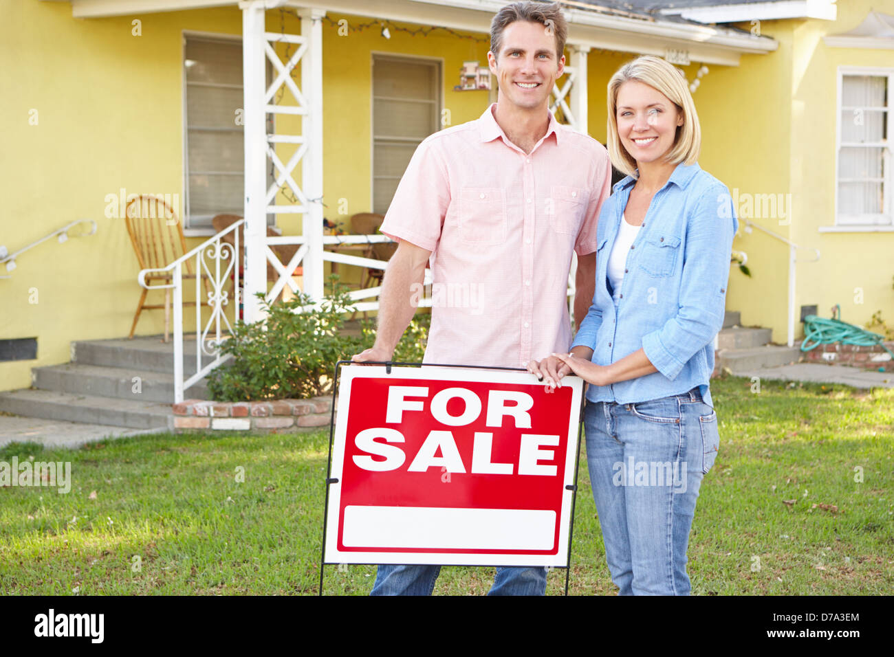 Couple Standing By For Sale Sign Outside Home Stock Photo - Alamy