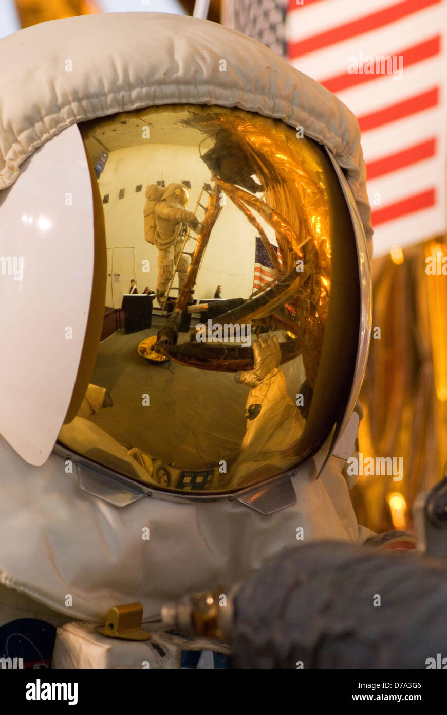Astronaut descending ladder Apollo Lunar Module reflected in second ...