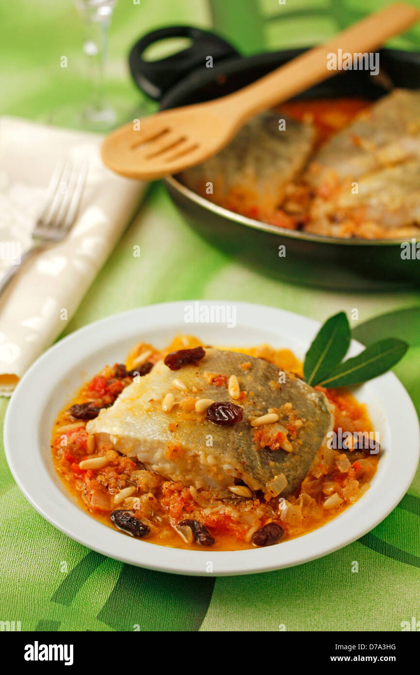 Cod with raisins and pine nuts. Recipe available Stock Photo - Alamy