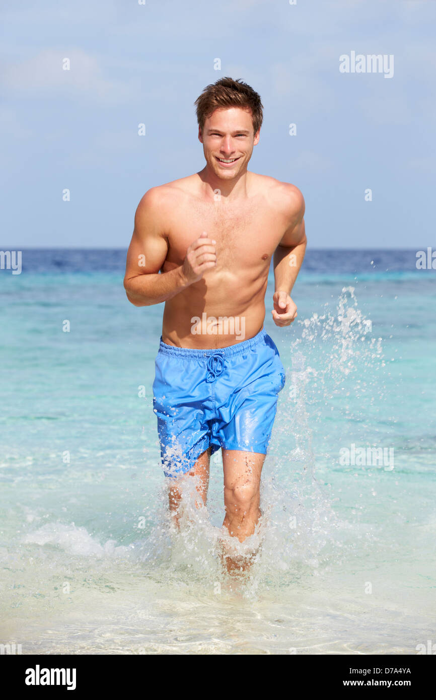 Man Splashing In Beautiful Tropical Sea Stock Photo - Alamy