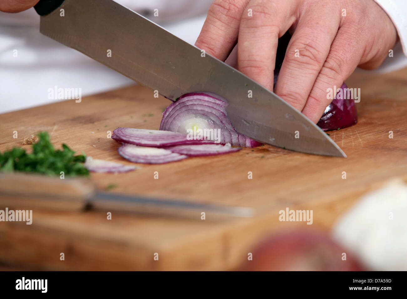 Chef chopping a red onion Stock Photo - Alamy