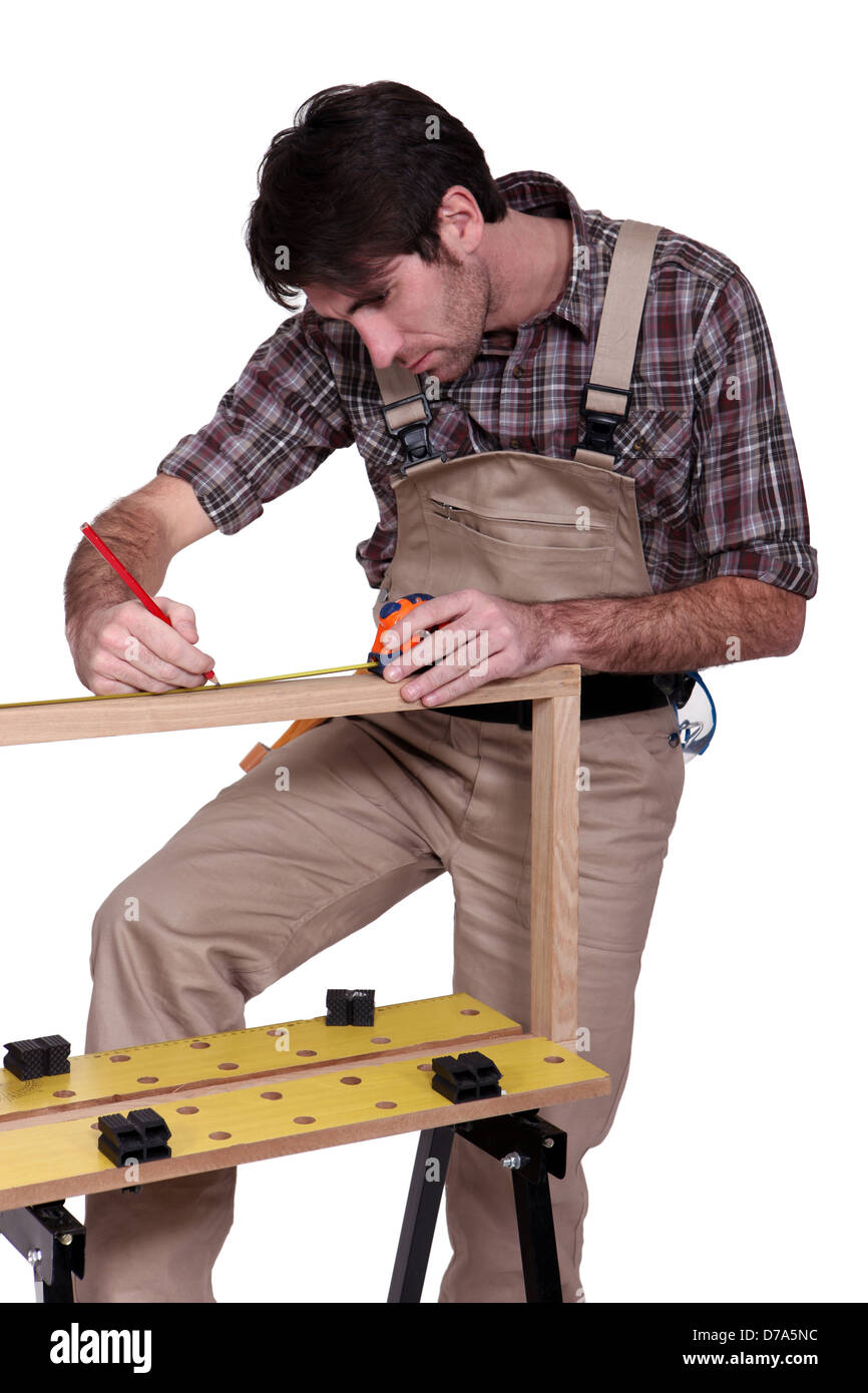 Man measuring wood frame Stock Photo - Alamy