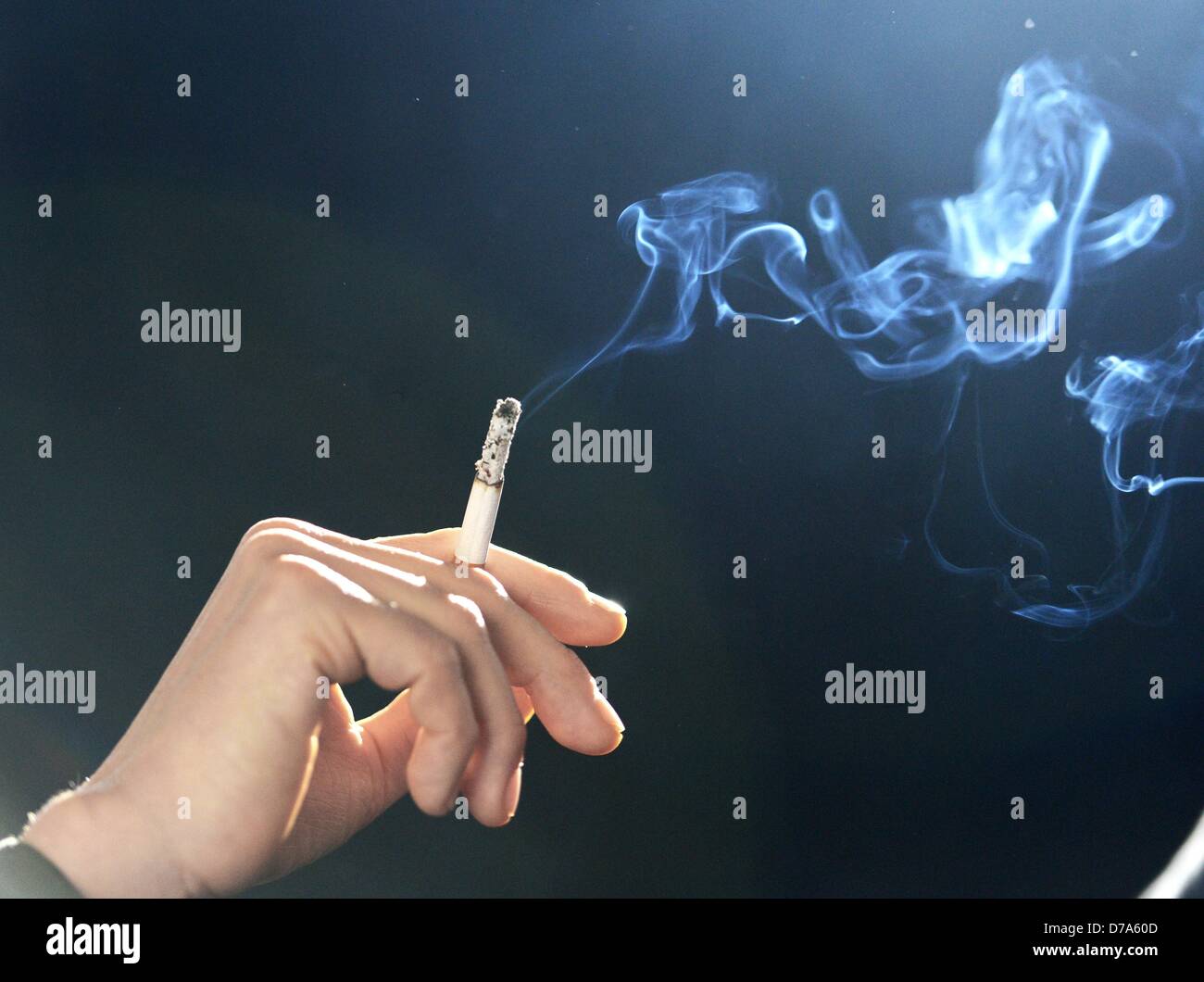 Smoke emanates from a burning cigarette and smoke in Berlin, Germany ...