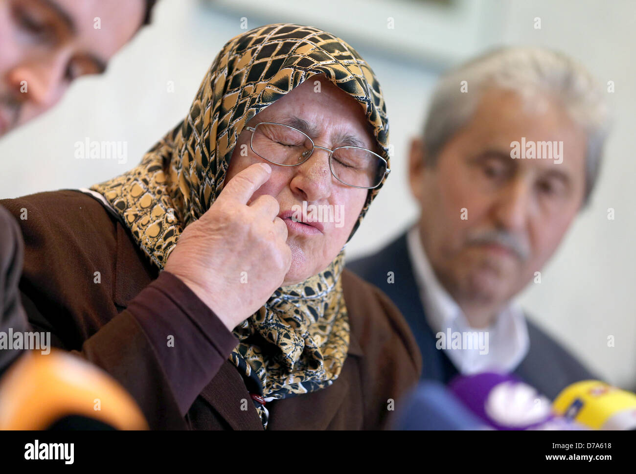 Mevlude Genc (C) and her husband Durmus (R) speak about the arson ...