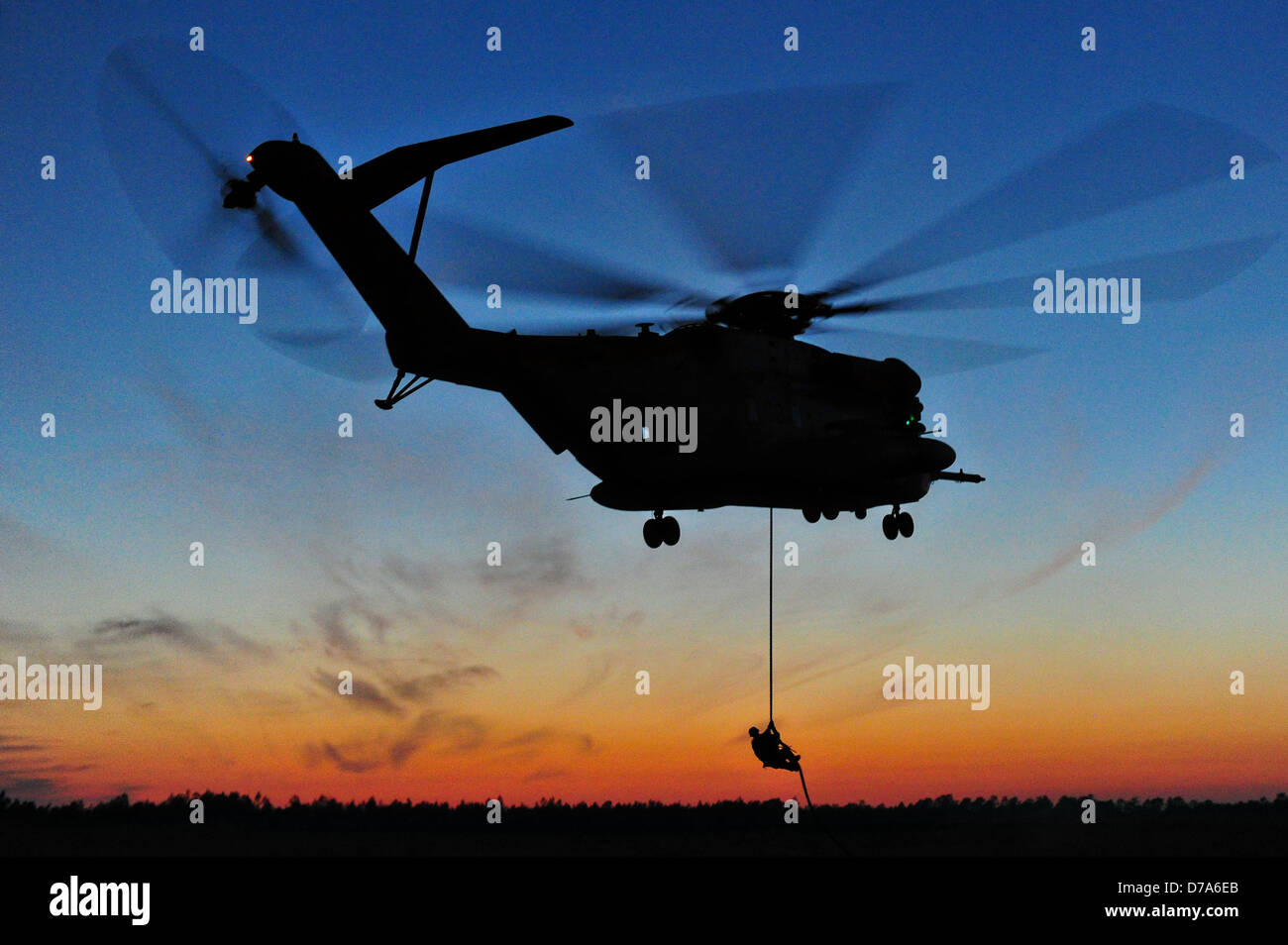 US special operations forces soldiers fast-rope from a helicopter ...