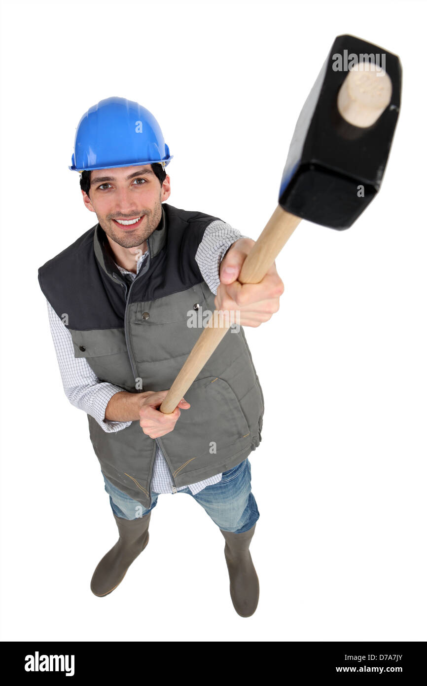 Construction worker holding up a mallet Stock Photo - Alamy