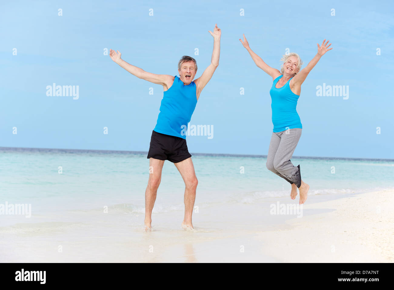 Happy man jumping on beach hi-res stock photography and images - Alamy