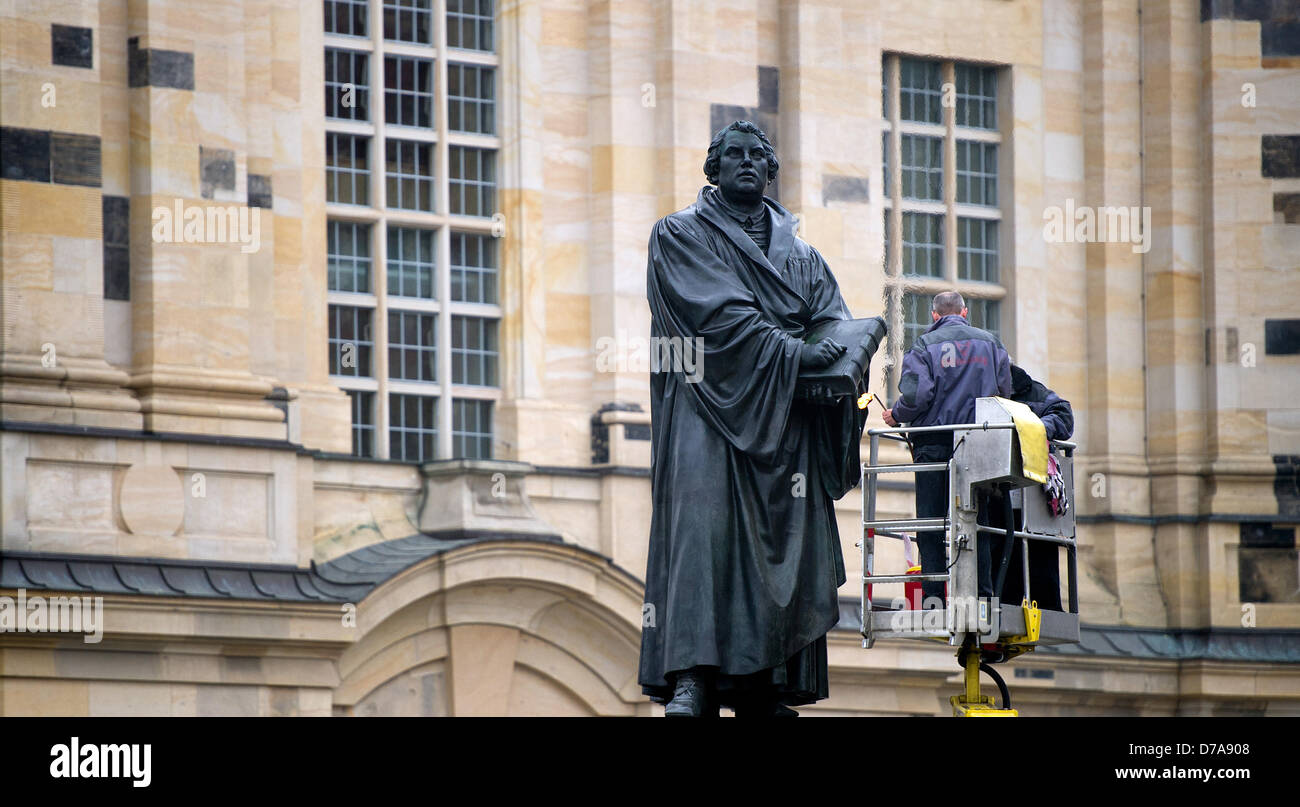 Two men work on the Martin Luther monument in front of the Church of ...