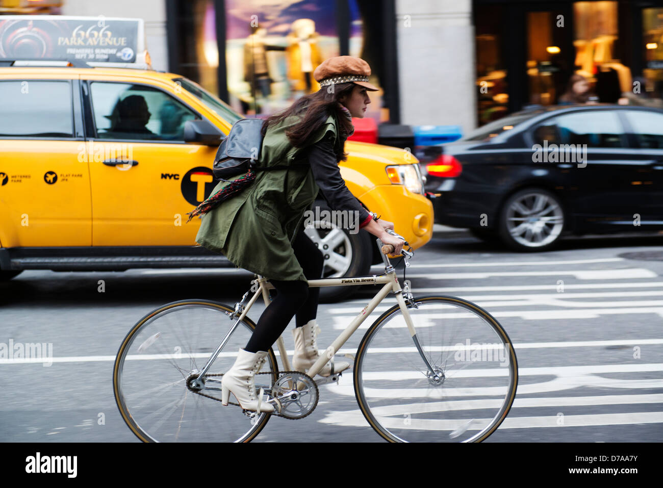 Well dressed young woman riding bicycle in New York City Stock Photo ...