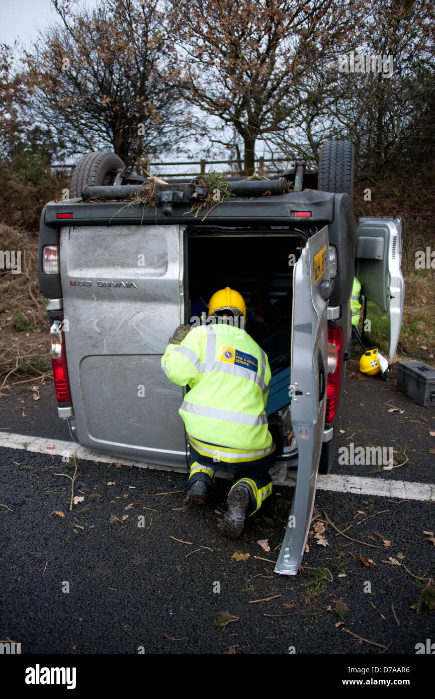 Transit Van Crash overturned on roof fireman rescue Stock Photo - Alamy
