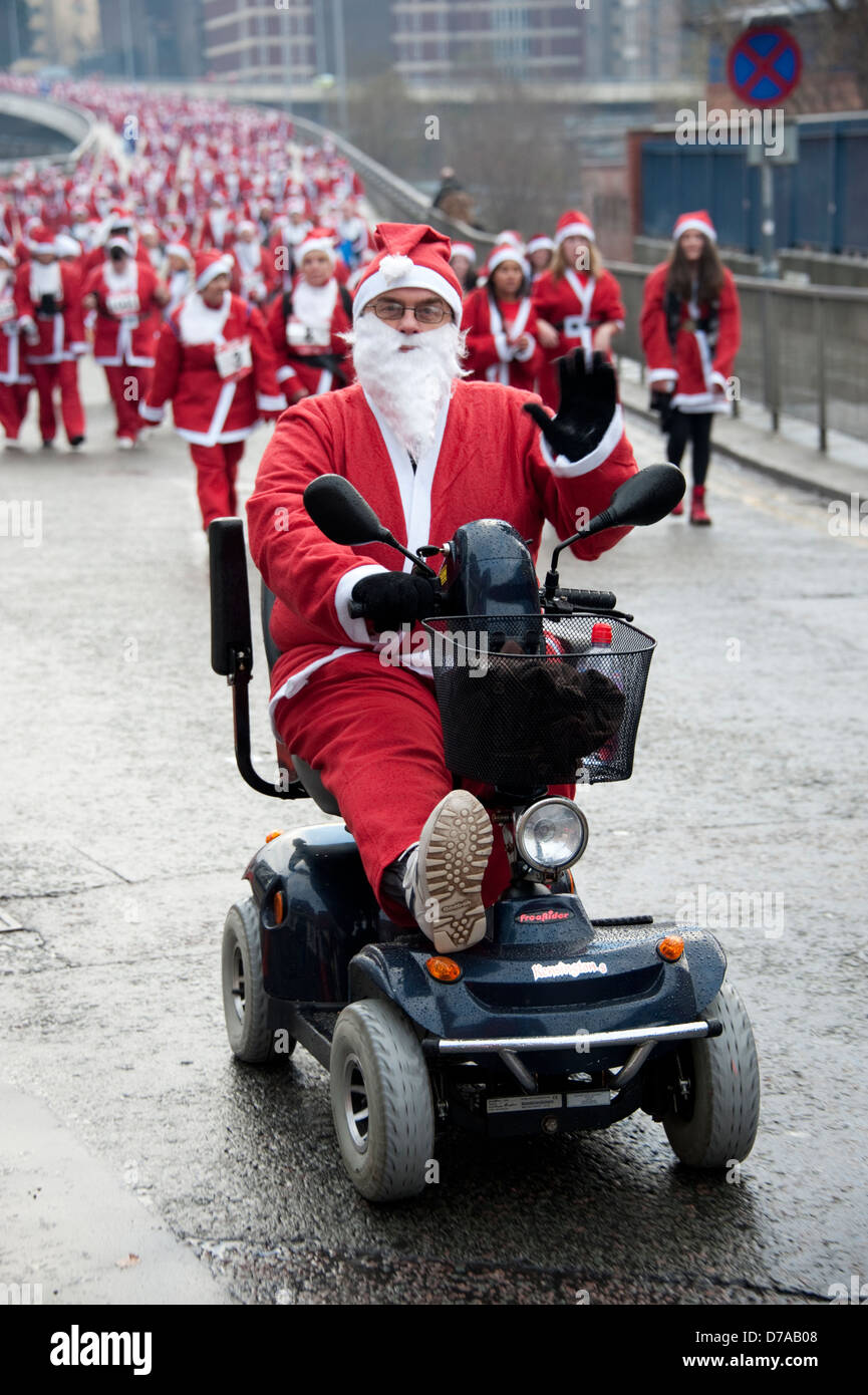 Disabled Father Christmas Santa on scooter buggy Stock Photo - Alamy