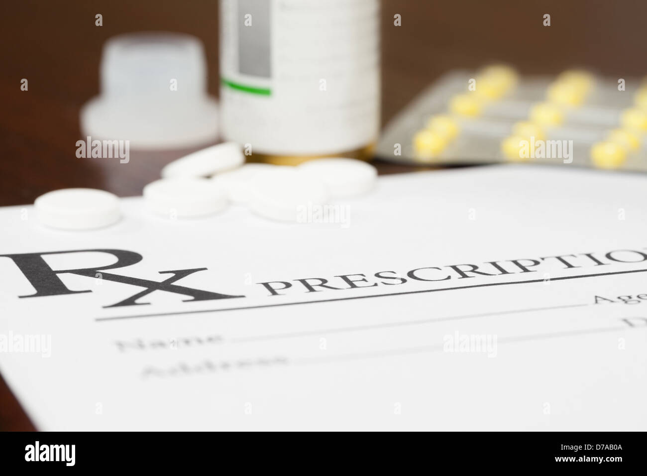Blank prescription with yellow pills on table Stock Photo - Alamy