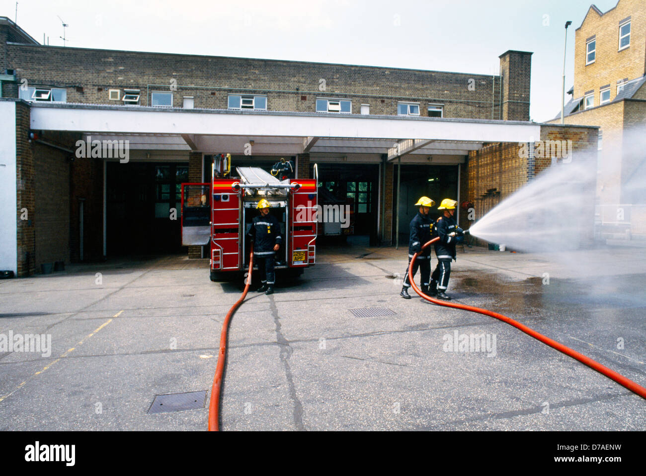 Firefighter using hose hi-res stock photography and images - Alamy