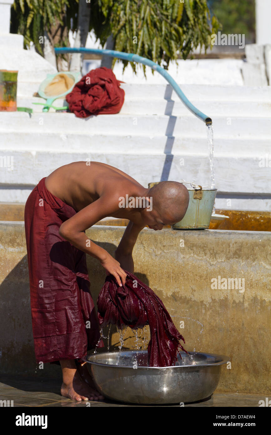 A monk washes his robes in Shwe Yaunghwe Kyaung Monastery near to Lake ...