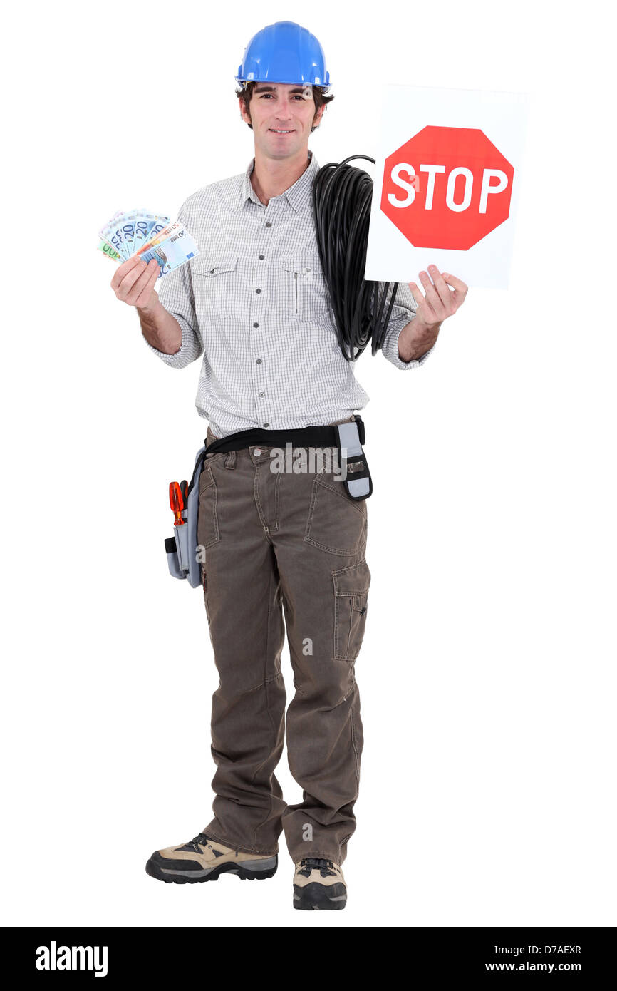 Electrician holding cash and stop sign Stock Photo - Alamy