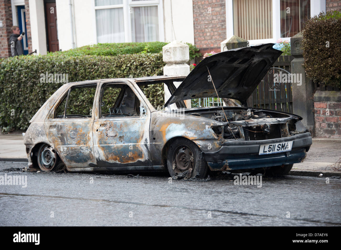 Burnt out charred car fire arson rioting Stock Photo - Alamy