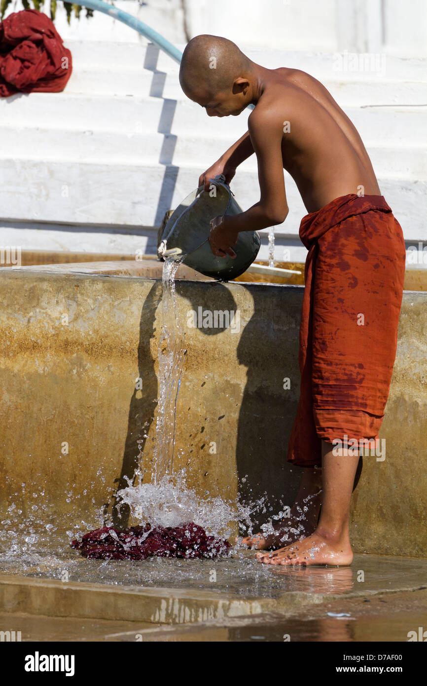 A monk washes his robes in Shwe Yaunghwe Kyaung Monastery near to Lake ...